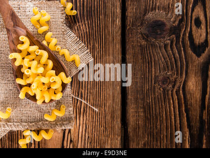 Pasta Curls (close-up shot) on dark wooden background Stock Photo - Alamy