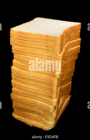 Tall stack of white bread on a black background Stock Photo - Alamy
