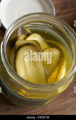 Gherkin slices, pickled in a glass jar. Lengthwise sliced gherkins ...