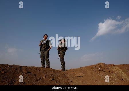 Women fighters with the Kurdish YPG line up for a briefing shown in a ...