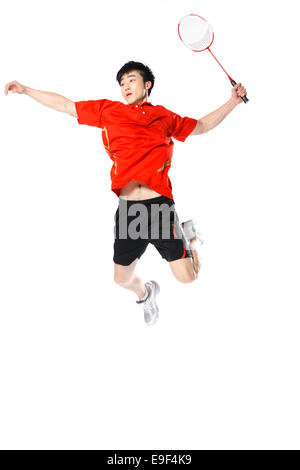 Asian man with badminton racket holding shuttlecock and ready in serve ...