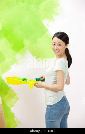 Young happy asian women decorating Christmas tree Stock Photo - Alamy