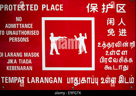 Multilanguage warning sign at Singapore industrial site Stock Photo - Alamy