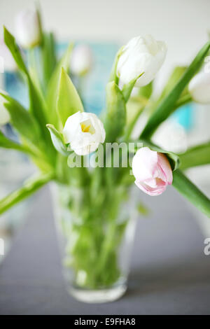 A selective focus shot of pink tulips in a garden surrounded by other ...