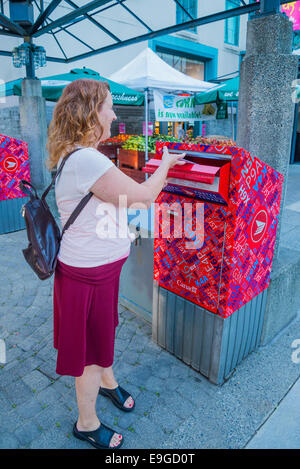 Woman posting a letter Stock Photo - Alamy