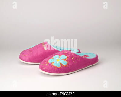 Pink warm women's slippers on a blue background Stock Photo - Alamy