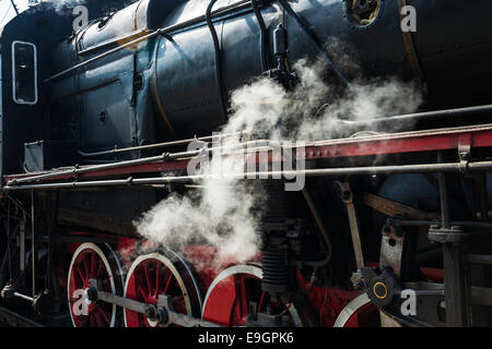 Steam locomotive in steam and ready to depart. Live hot steam around ...