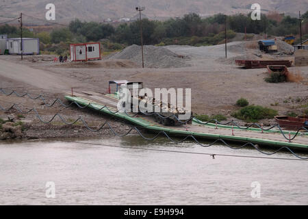 A truck loaded with sheep crossing a pontoon bridge over the Tigris ...