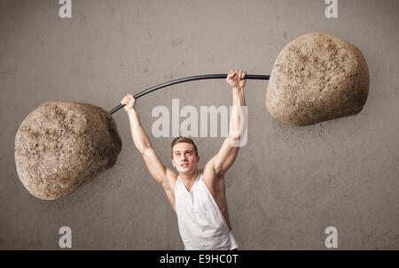 muscular man lifting large rock stone weights Stock Photo - Alamy