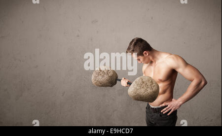 muscular man lifting large rock stone weights Stock Photo - Alamy