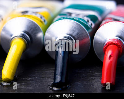 Paints squeezed out of a tube on a white sheet. They are for drawing on ...