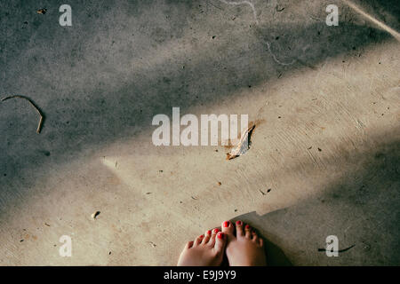 woman's feet with red painted toenails on blue swimming pool tiles ...
