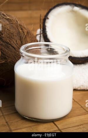 coconut fruit with a jar filled with coco milk Stock Photo - Alamy