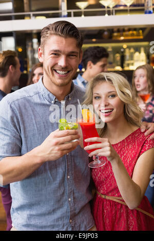 Happy couple drinking cocktails Stock Photo - Alamy