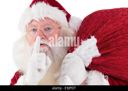 Santa asking for quiet with bag Stock Photo - Alamy
