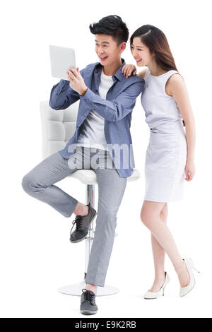 Happy modern couple surfing the net and working on laptop at home.photo ...