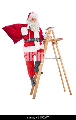 Climbing red santa claus on ladder agains white brick wall Stock Photo ...