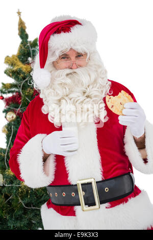 Smiling santa claus eating a cookie Stock Photo - Alamy