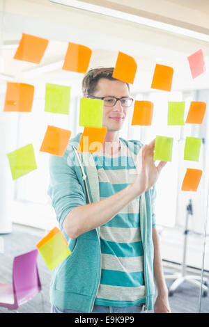smiling businessman at office glass wall Stock Photo - Alamy