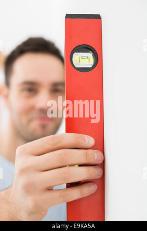 Man using spirit level on new wooden door frame FOR EDITORIAL USE ONLY ...