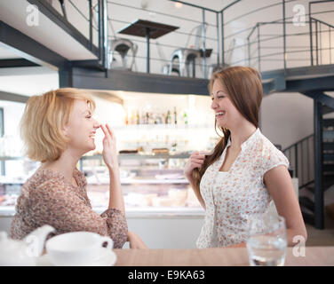 two young women gossiping Stock Photo - Alamy