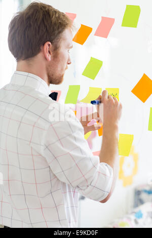 Businessman holding pen writing on paper document working, Close up ...