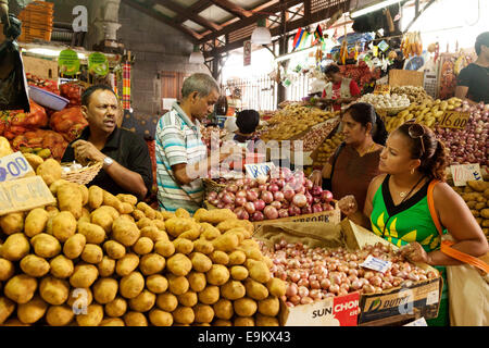 Local mauritian people buying fruit/veg at the indoor food market ...