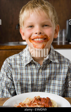 Boy eating messy spaghetti dinner from bowl sloppy manners child ...