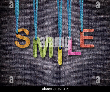 Smile Letters hanging strings with blue sackcloth background Stock ...