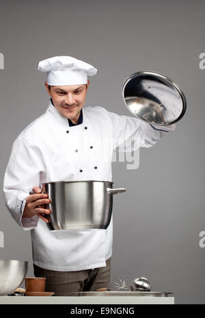 Professional chef with cooking pot on white background Stock Photo - Alamy