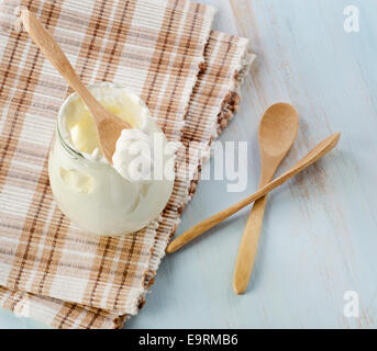 Fresh yogurt in glass jar with berry fruits on dark background. Healthy ...