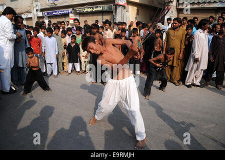Shiite Muslims flagellate themselves during a Muharram procession in ...