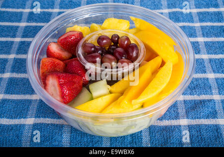 Sliced fresh strawberries in plastic cups with dipping seasoning served ...