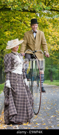 Velocipedists, men and women on historic bikes and in period costumes ...