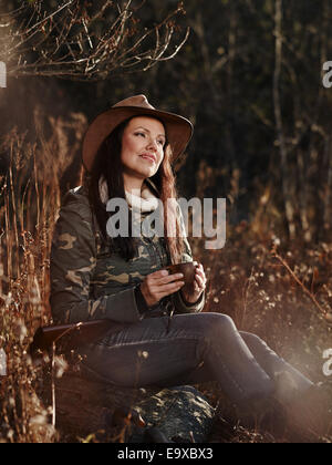 Waterfowl hunting, the female hunter having a coffee break, autumnal ...