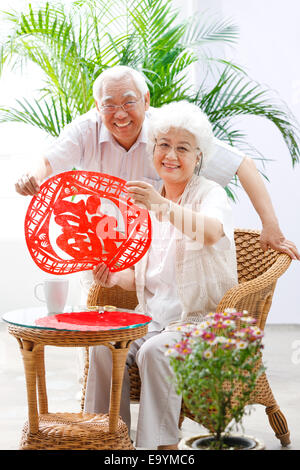 Senior Chinese couple in living room Stock Photo - Alamy