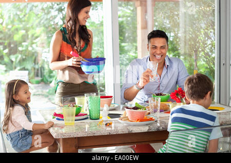 Family at a dining table Stock Photo - Alamy