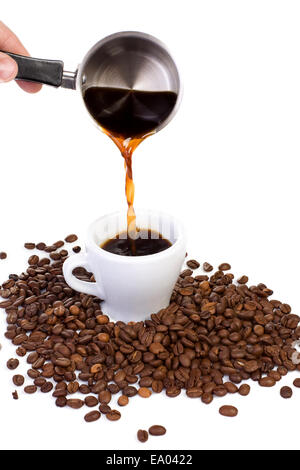 Coffee in white cup and clay cezve on wooden background. Toned Stock ...