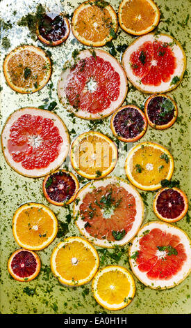 Red cocktail with blood oranges and mint on the blue concrete table ...
