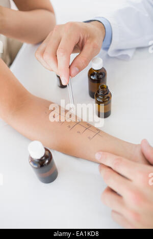 Doctor dropping medicine on hand of patient Stock Photo - Alamy