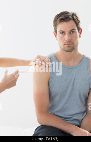 woman and an injection on her arm Stock Photo - Alamy