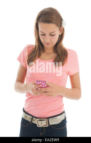 Teenager girl standing over pink background with hands together and ...