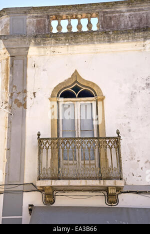 Ornate Moorish style window frame in white wall with wooden shutters ...