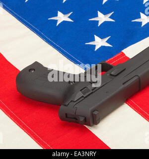 Handgun laying over USA flag - studio shoot Stock Photo - Alamy