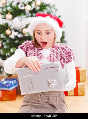 surprised teen girl hold present box on yellow background Stock Photo ...
