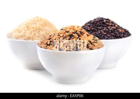 Mix of different varieties of rice in bowl on a wooden background ...