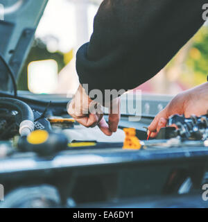 Man fixing a car Stock Photo - Alamy