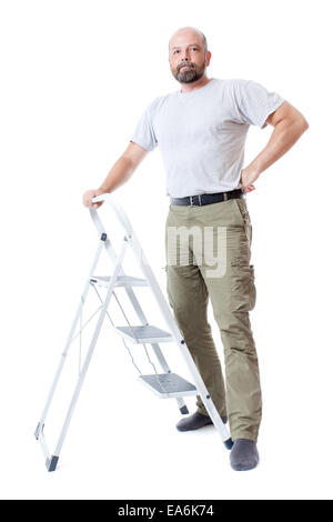 Caucasian man with beard by ladder smiling in love showing heart symbol ...