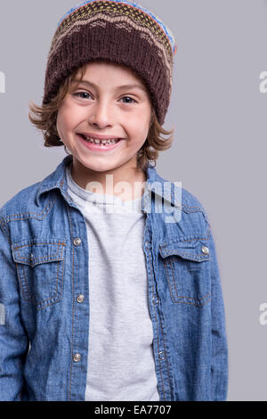 Little fashion boy posing over grey background Stock Photo - Alamy