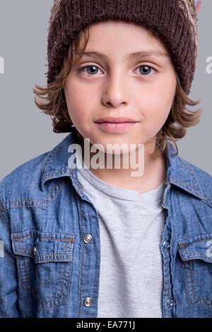 Little fashion boy posing over grey background Stock Photo - Alamy